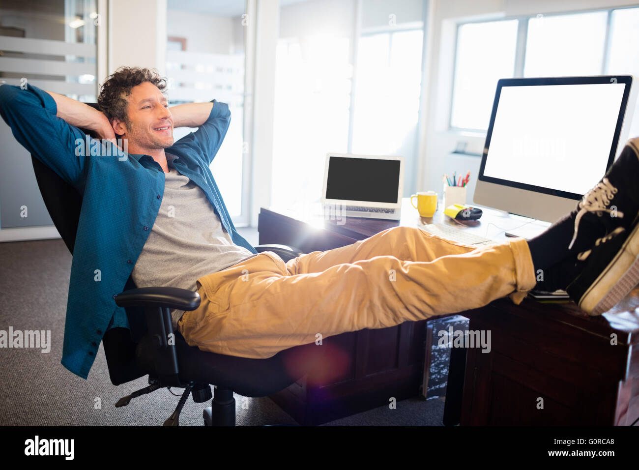 Businessman relaxing on chair hi-res stock photography and images - Alamy