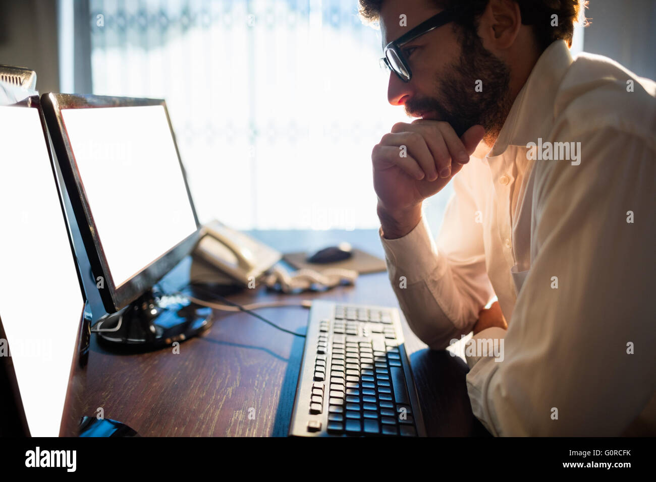 Businessman working with a computer Stock Photo - Alamy