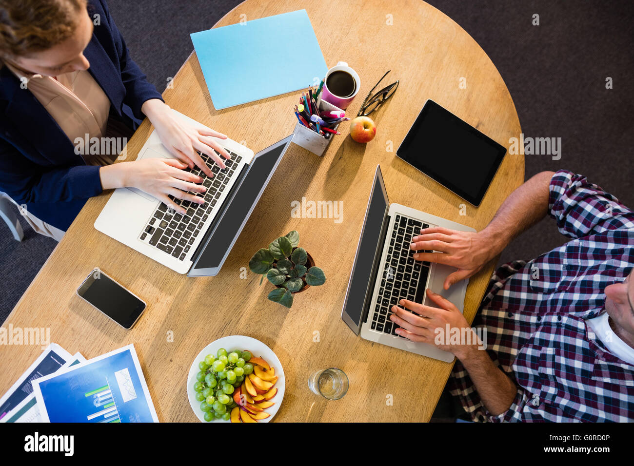 Colleagues using laptop Stock Photo - Alamy