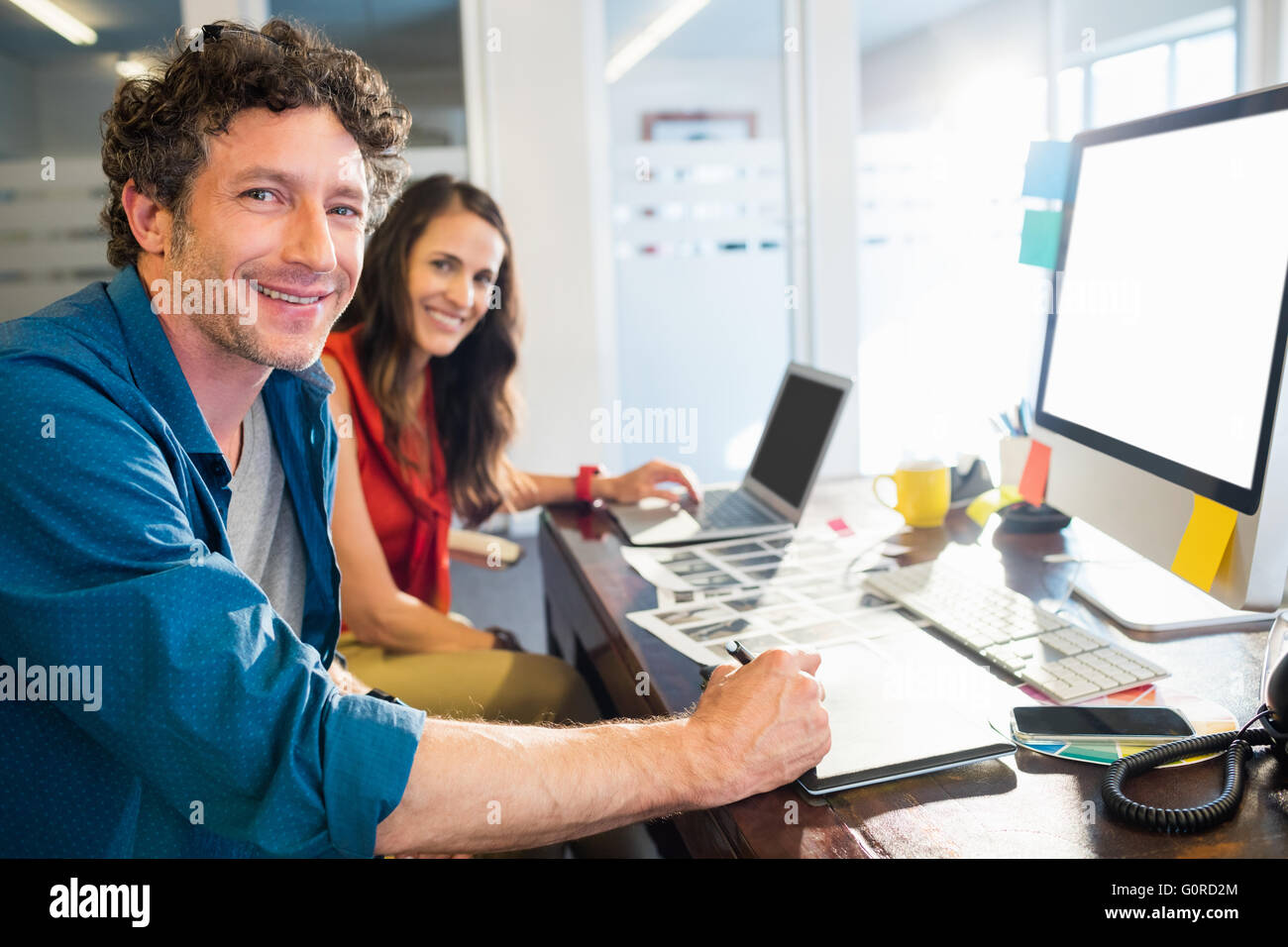 Colleagues using technology Stock Photo - Alamy