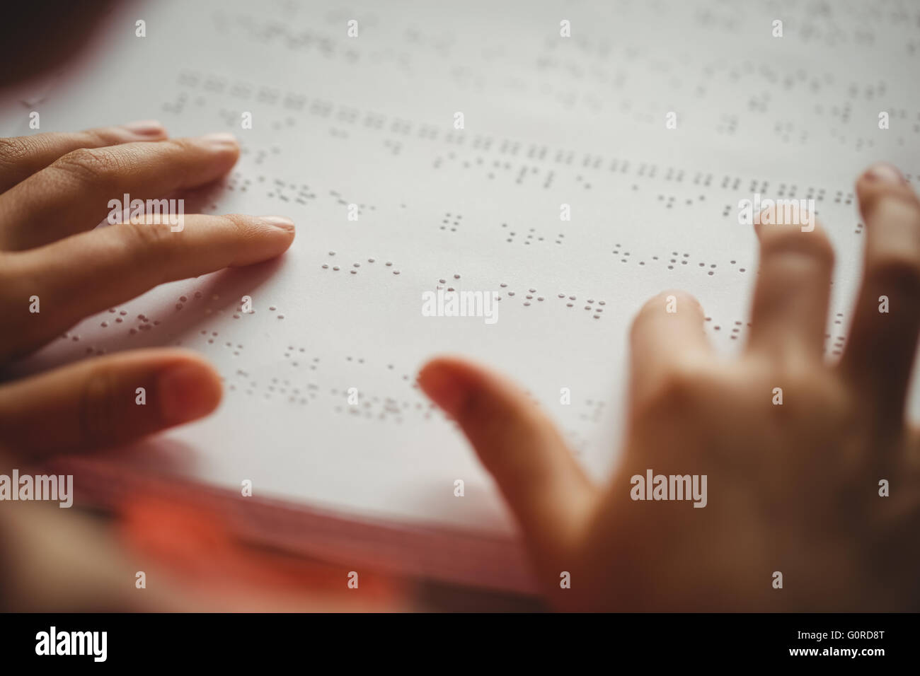 Girl using braille to read Stock Photo - Alamy