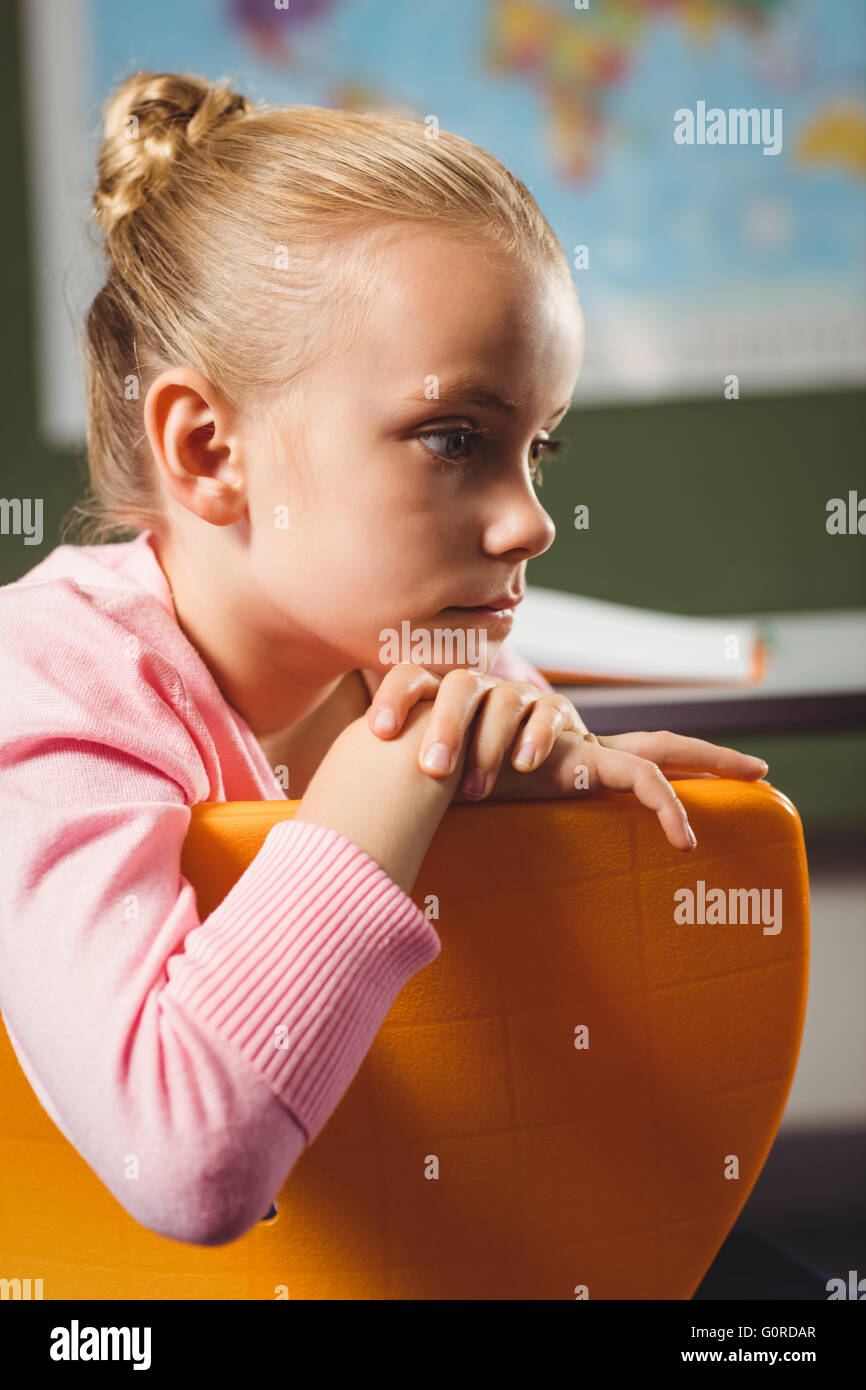 Girl leaning against chair Stock Photo - Alamy