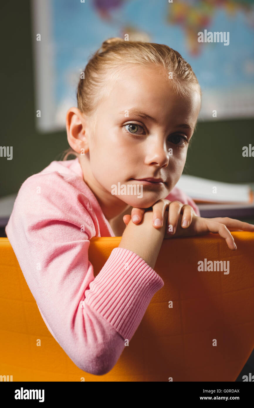 Girl leaning against chair Stock Photo - Alamy
