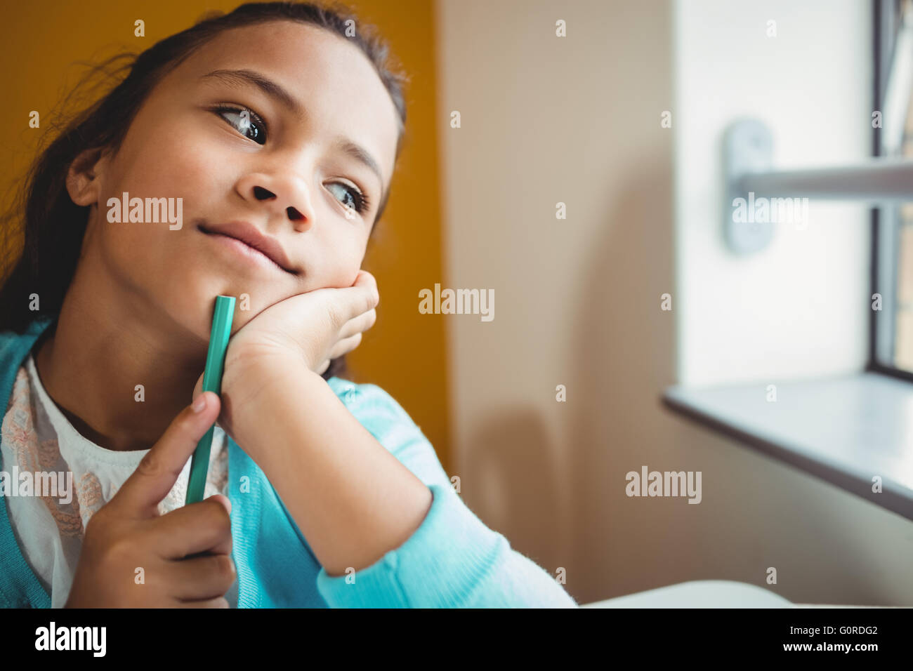 Girl sitting at a desk Stock Photo - Alamy