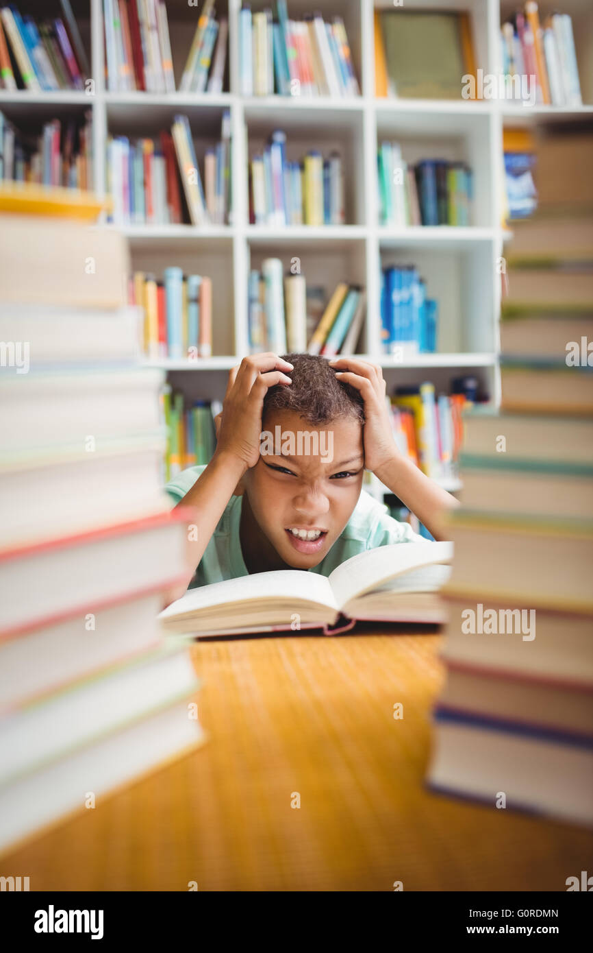 Upset boy sitting at a desk Stock Photo - Alamy