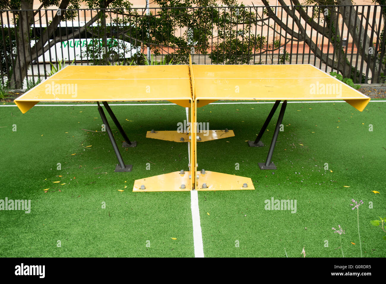 An outdoor yellow metal table tennis table Stock Photo - Alamy