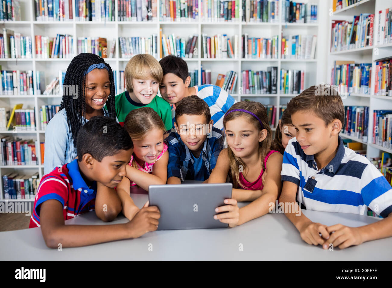 Front view of pupils using tablet pc Stock Photo - Alamy