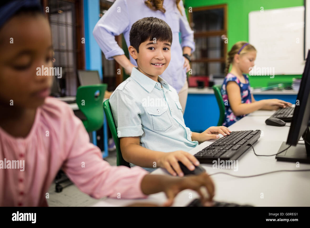 Children looking their computer Stock Photo - Alamy