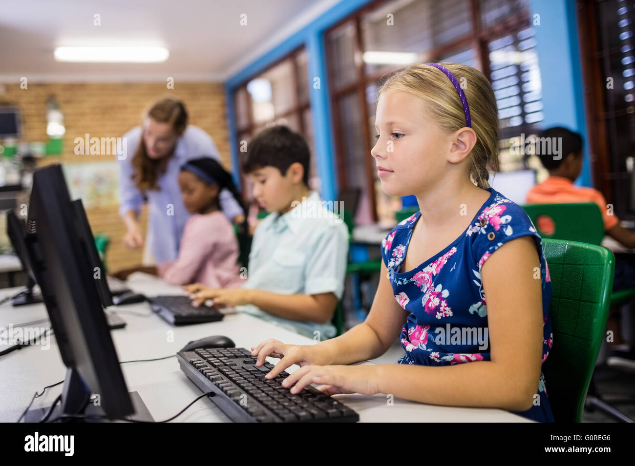 Children looking their computer Stock Photo - Alamy