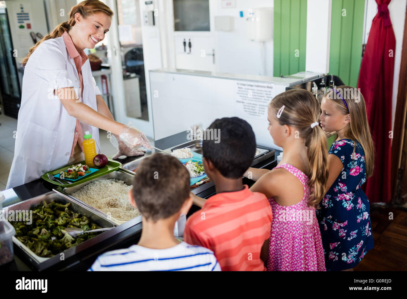 Cooker serving children Stock Photo - Alamy