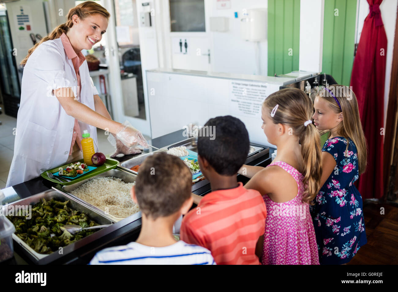 Cooker serving children Stock Photo - Alamy