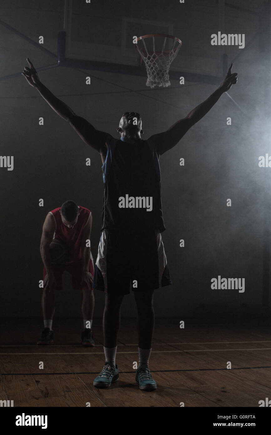 Victorious basketball player raising his arms up Stock Photo - Alamy