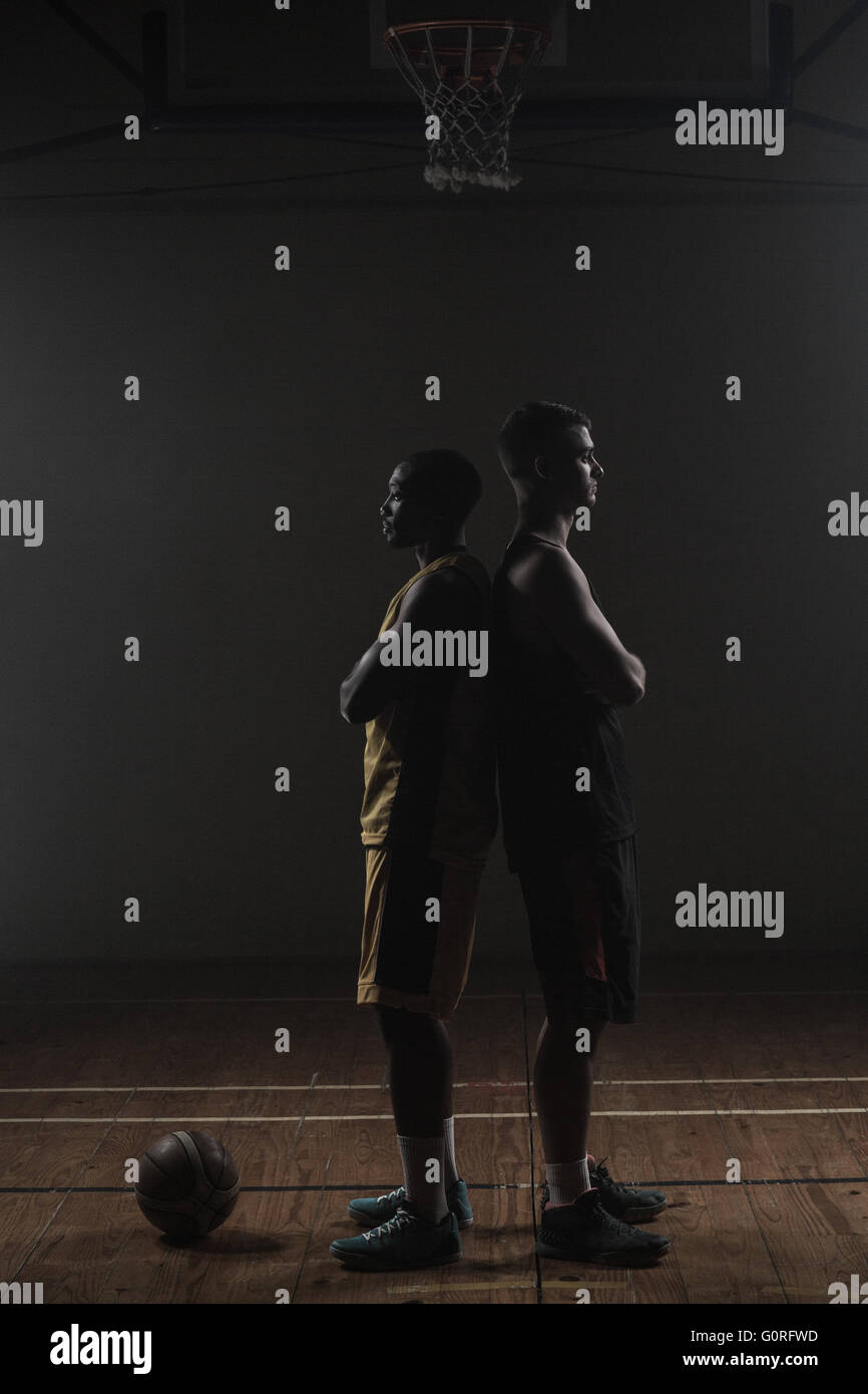 Basketball players posing back to back Stock Photo - Alamy