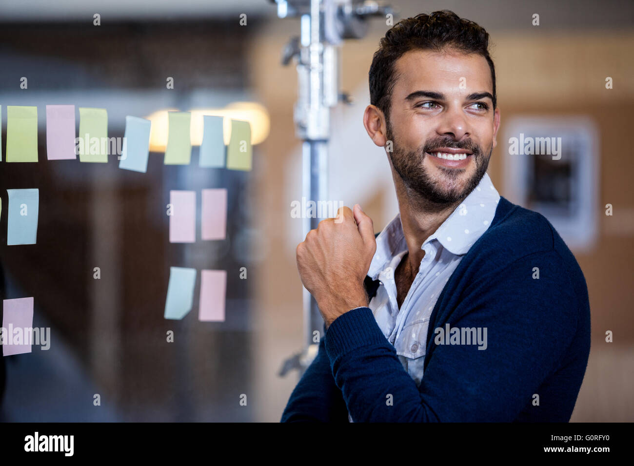 A young businessman looking away Stock Photo - Alamy