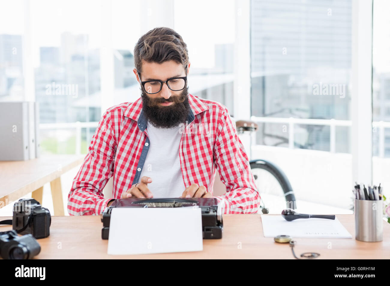 Hipster man using a typewriter Stock Photo - Alamy