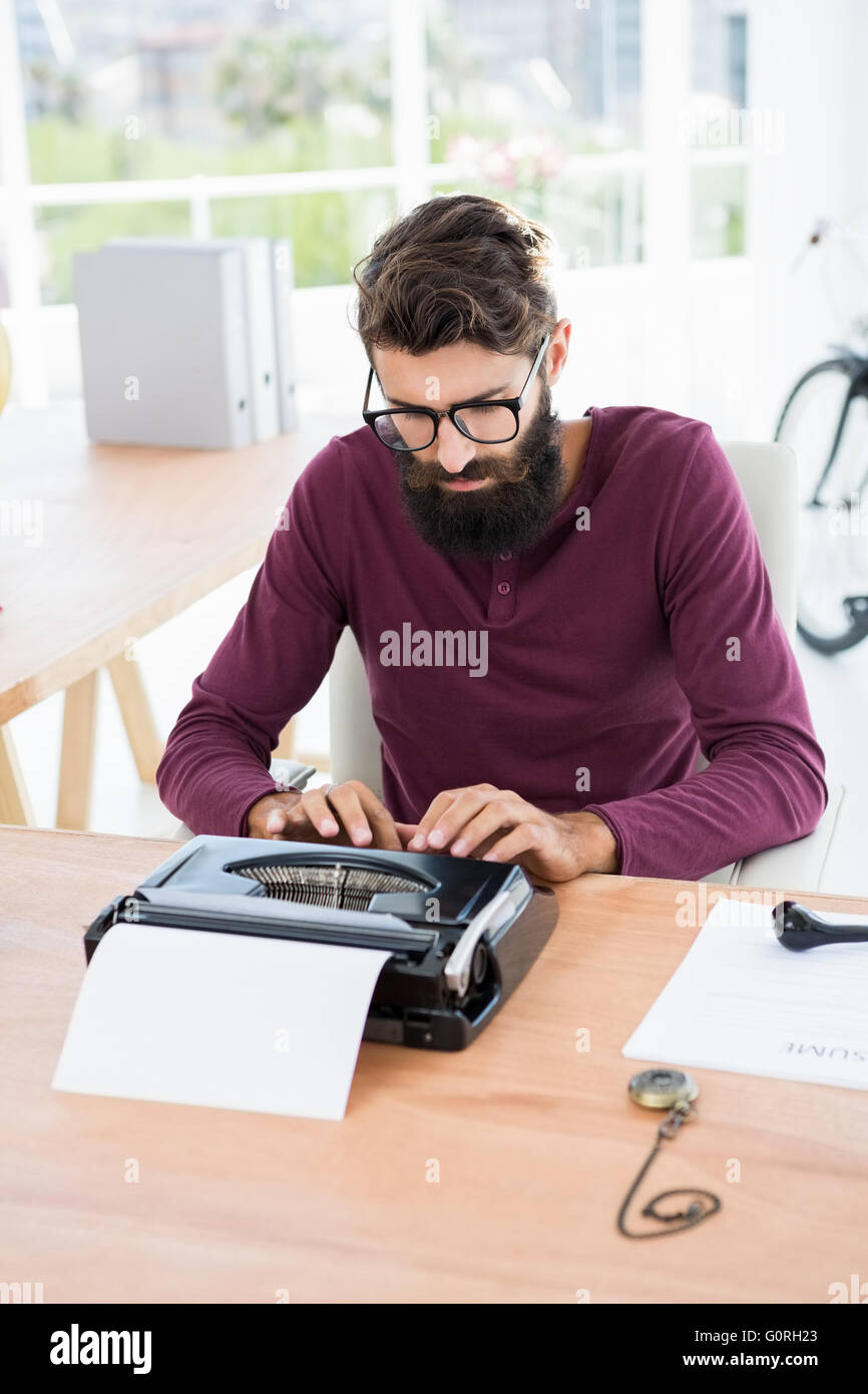 Hipster man using a typewriter Stock Photo - Alamy