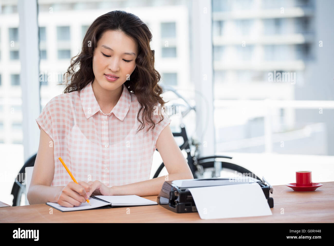 Hipster woman writing on her notebook Stock Photo - Alamy