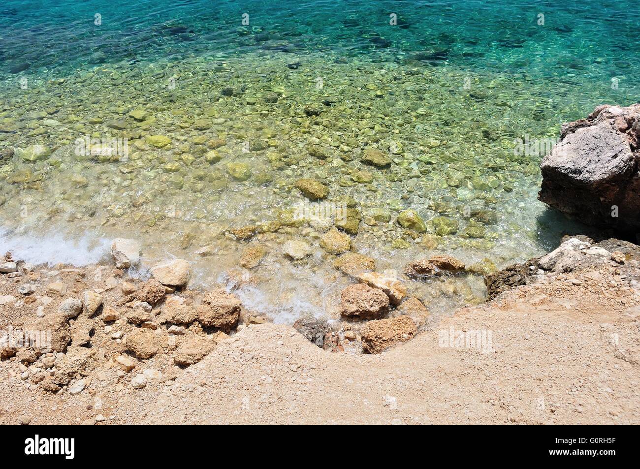 Beautiful beach with big stones and crystal clear adriatic sea in ...