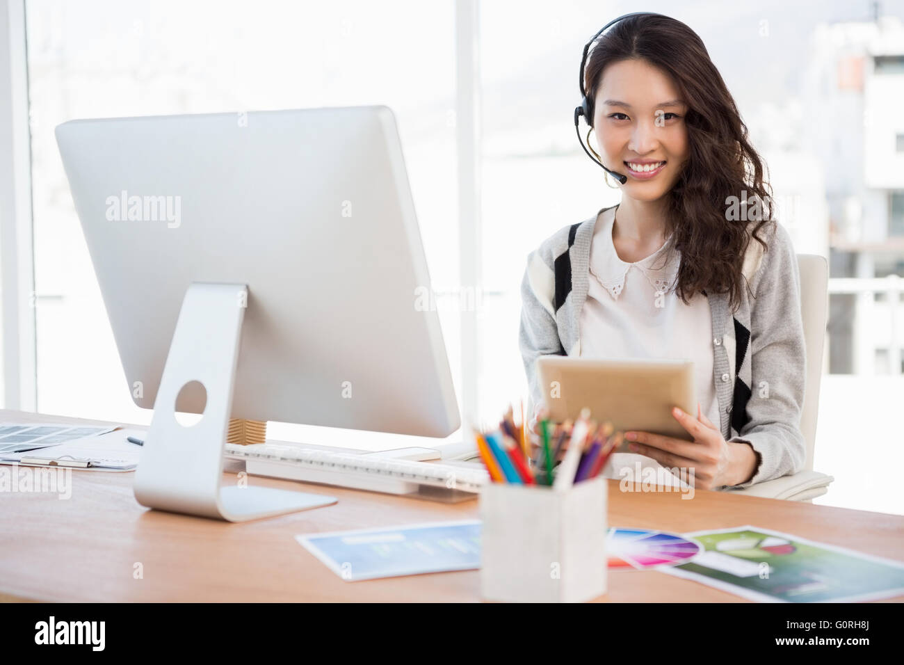 A woman is working at her computer desk Stock Photo - Alamy
