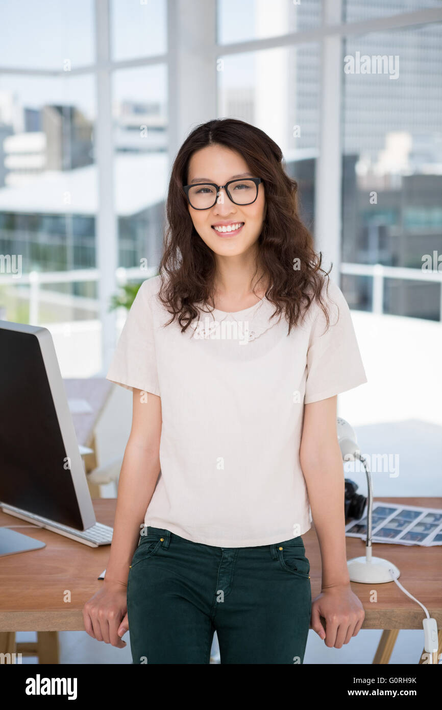Portrait of a young woman standing by chair hi-res stock photography ...