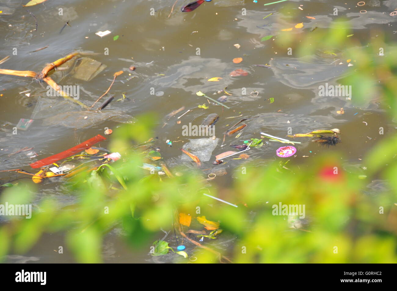 Plastic waste floating down a river causing pollution in a river in ...
