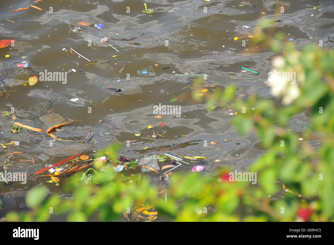 Plastic waste floating down a river causing pollution in a river in ...