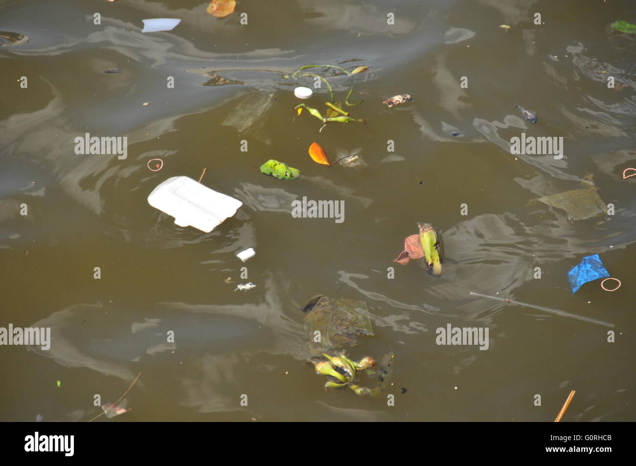 Plastic waste floating down a river causing pollution in a river in ...