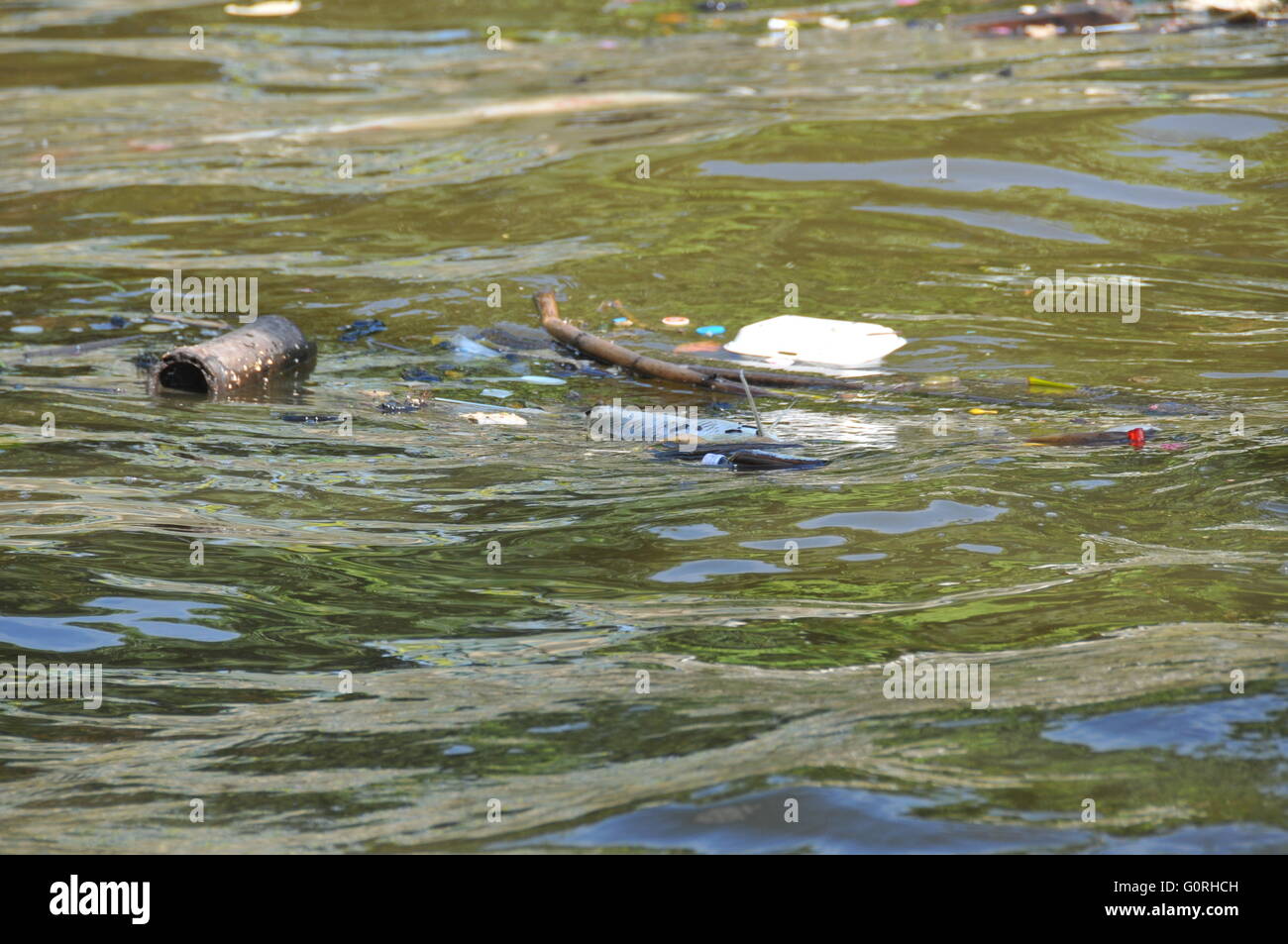 Plastic waste floating down a river causing pollution in a river in ...