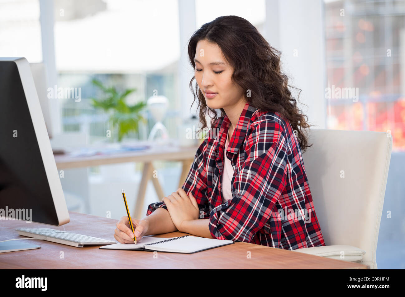 Hipster taking notes in a notebook Stock Photo - Alamy