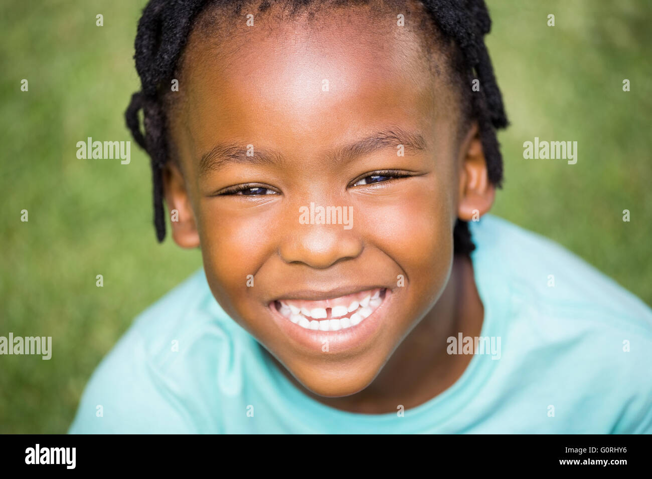 Black boy sitting on grass hi-res stock photography and images - Alamy