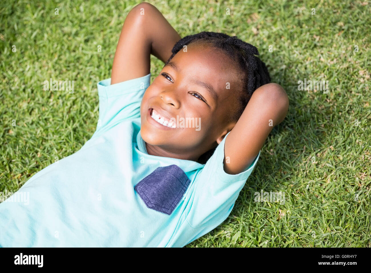 Boy lying on grass hi-res stock photography and images - Alamy