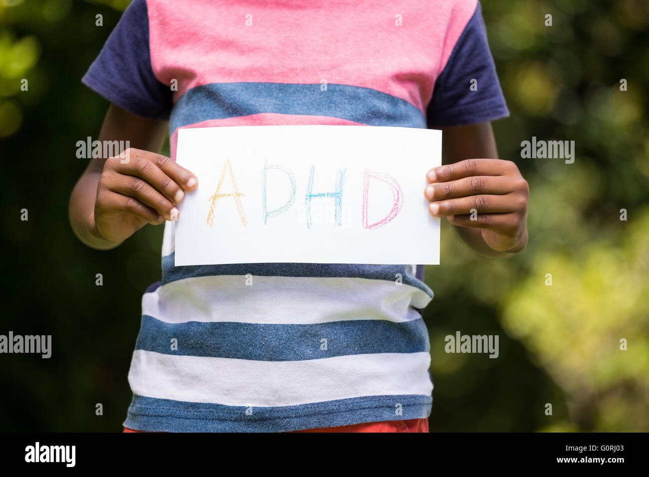 Boy showing a poster with ADHD Stock Photo - Alamy
