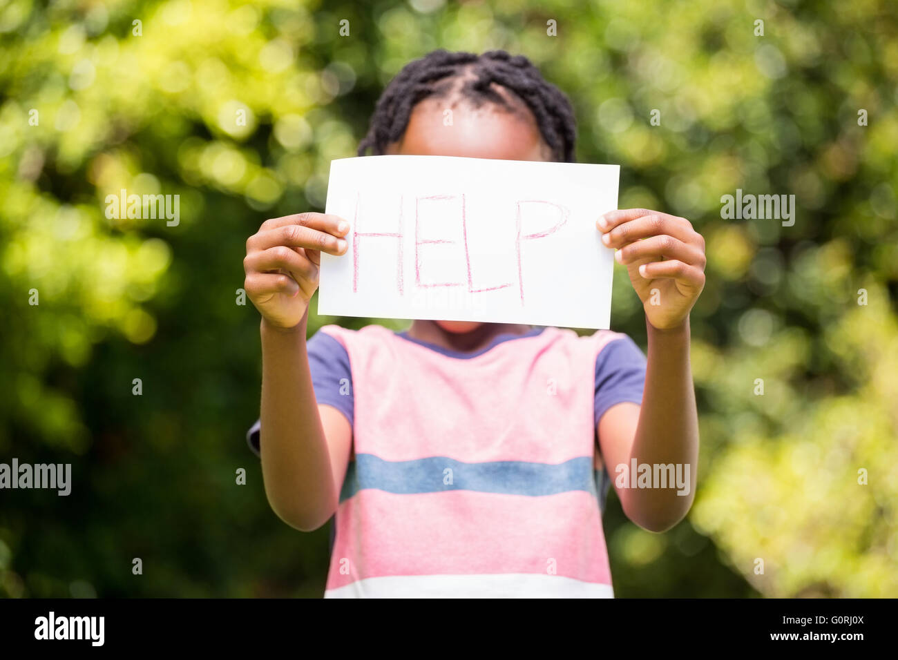 Boy holding a poster with help Stock Photo - Alamy