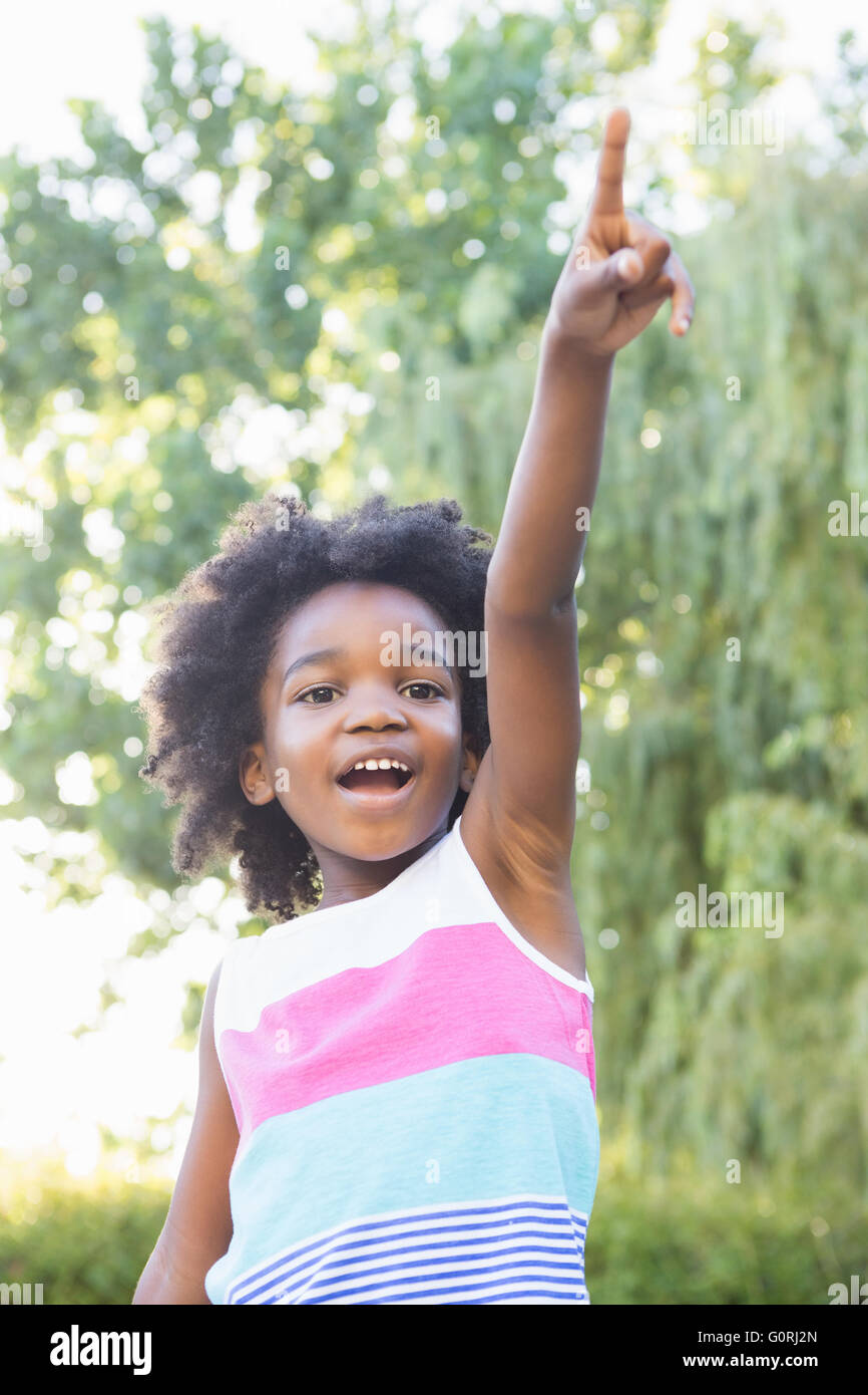 Smiling child with hand up Stock Photo - Alamy