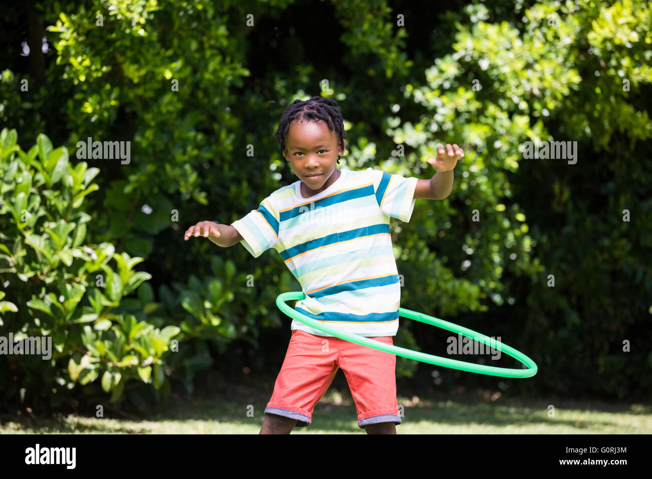 A kid playing with a hoop Stock Photo - Alamy