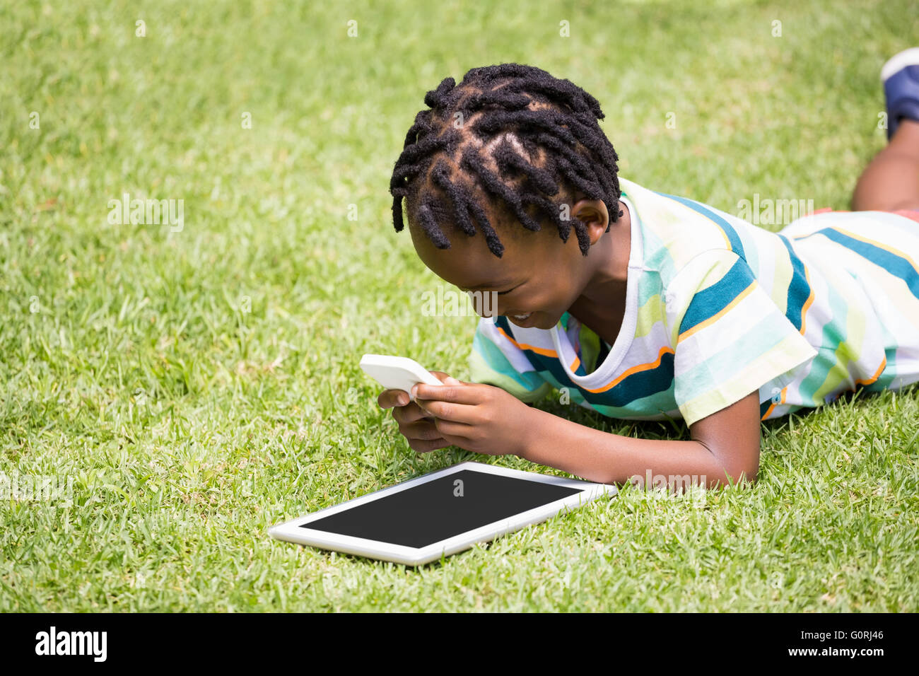 A kid playing with a mobile phone Stock Photo - Alamy