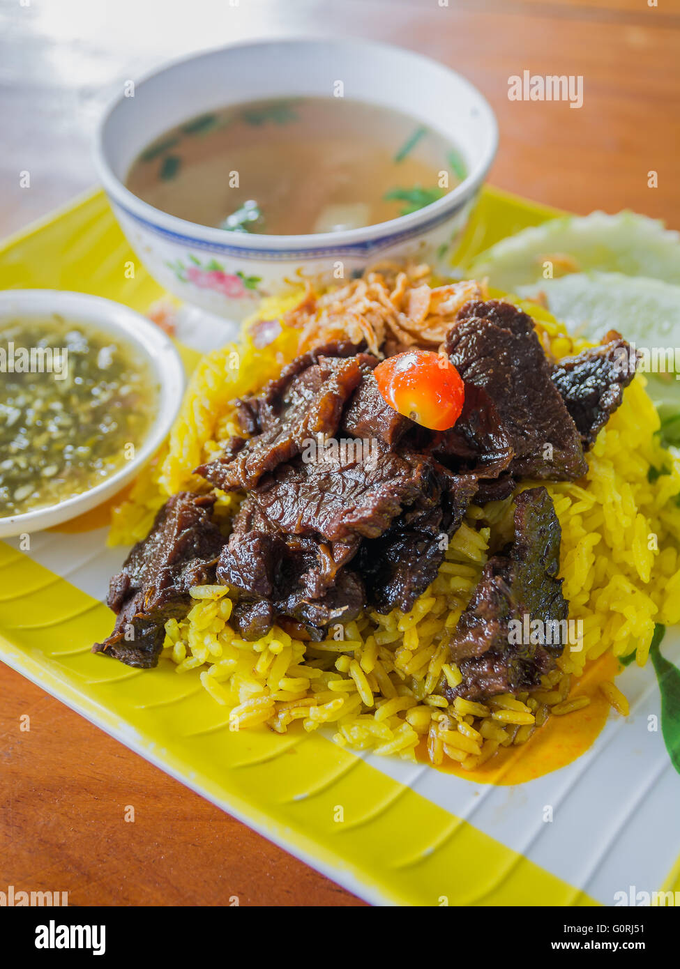 Roast beef with rice, yellow rice dishes Stock Photo - Alamy
