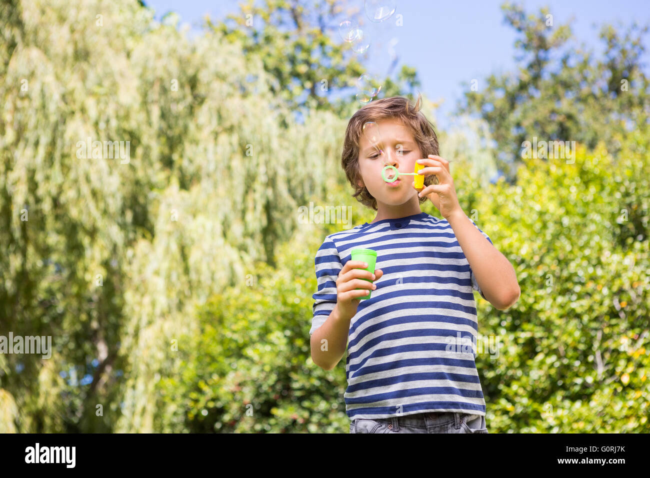 Cute boy playing with bubbles Stock Photo - Alamy