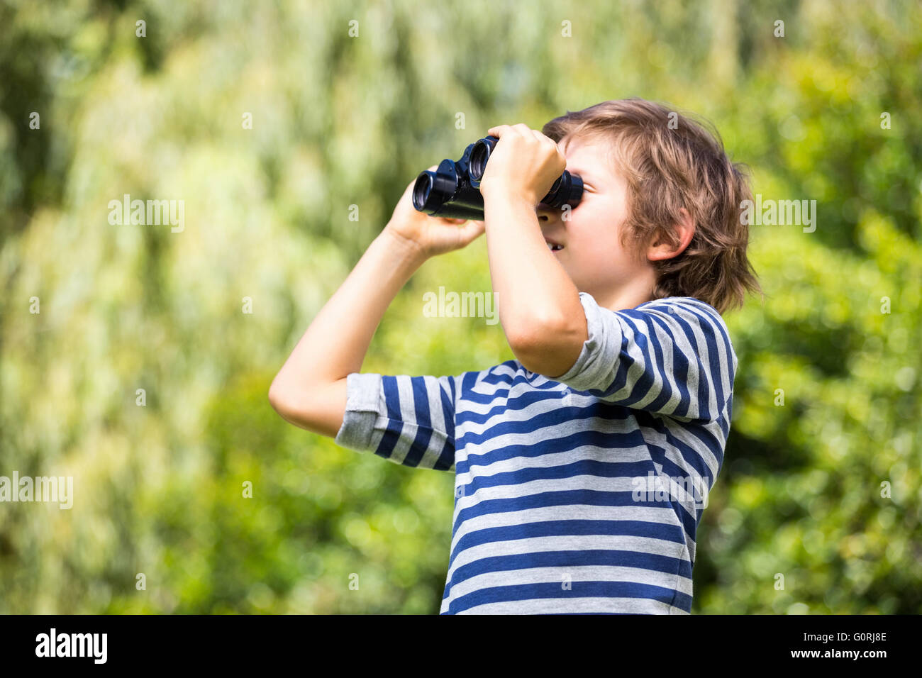 Portrait of cute boy looking something with binoculars Stock Photo - Alamy