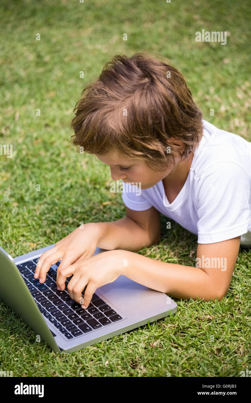Child lying using a laptop Stock Photo - Alamy