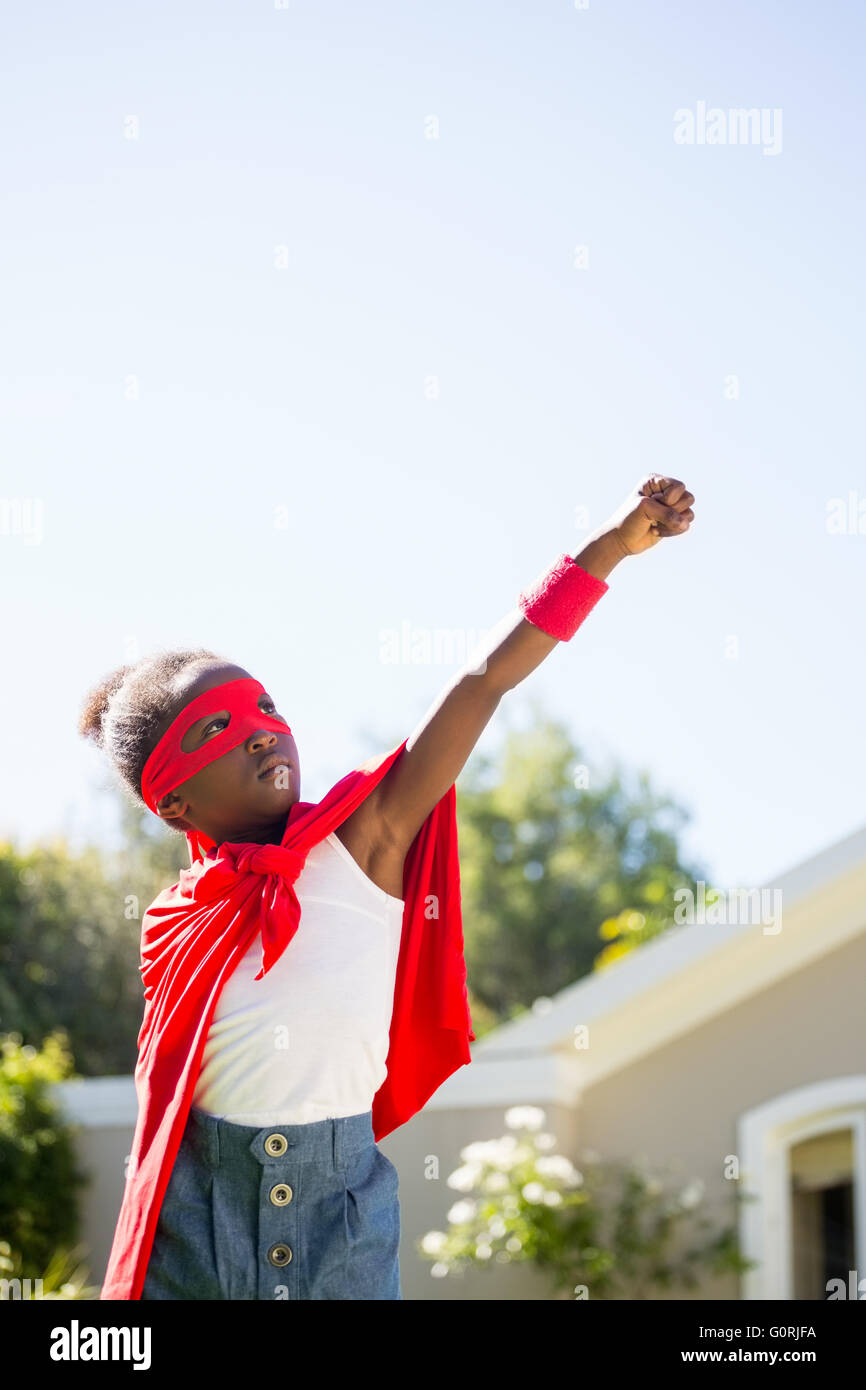 Cute mixed-race girl wearing a fancy dress and throwing up arm Stock ...