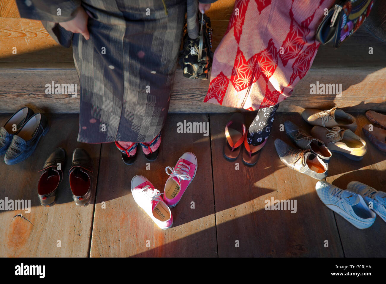Visitors in traditional kimono step into their geta sandals at Kiyomizu ...