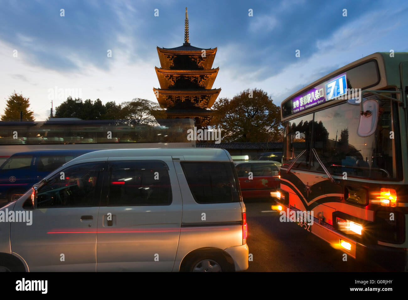 A twilight view shows traffic on Omiya Avenue passing by Toji Temple's ...