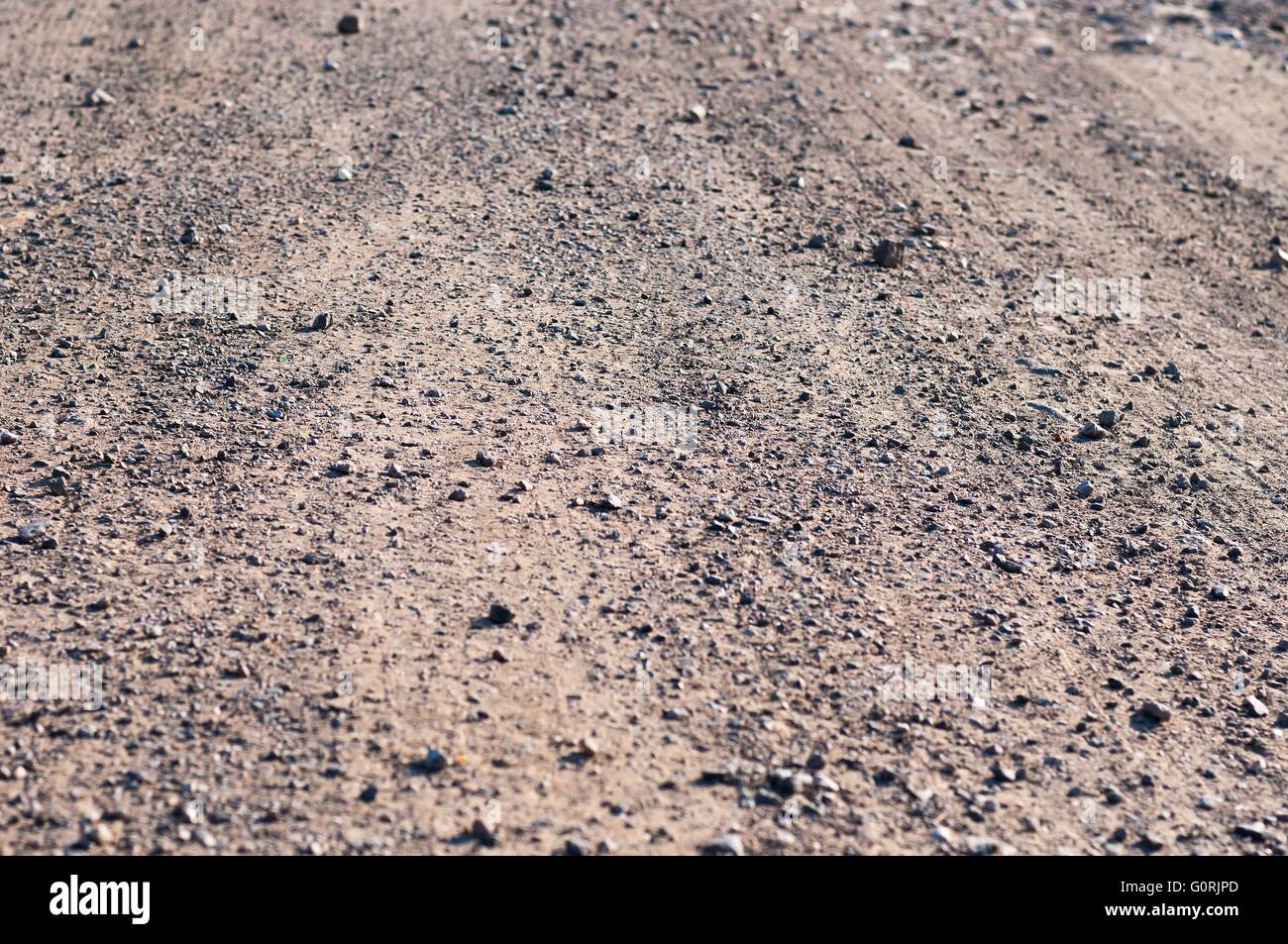 Terrain road with small rocks on the ground viewed from near the ground ...
