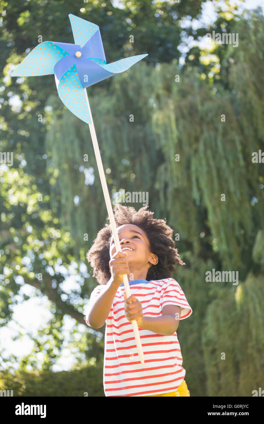 Happy boy is playing with pinwheel Stock Photo - Alamy