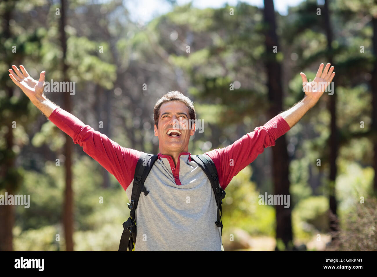 Man smiling and throwing up arms Stock Photo - Alamy