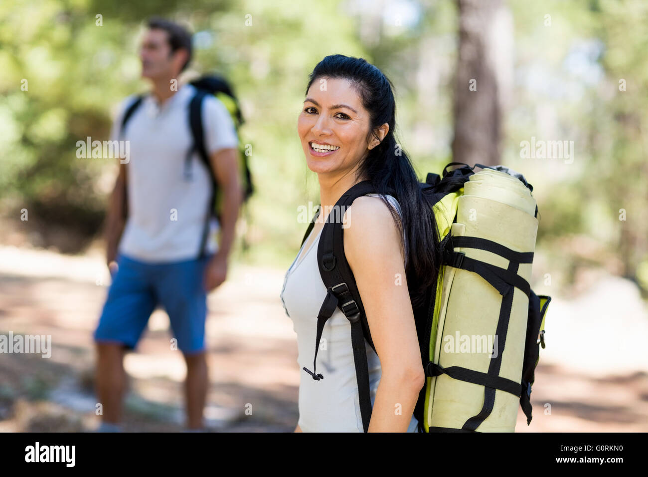 Woman smiling and posing with a backpack Stock Photo - Alamy