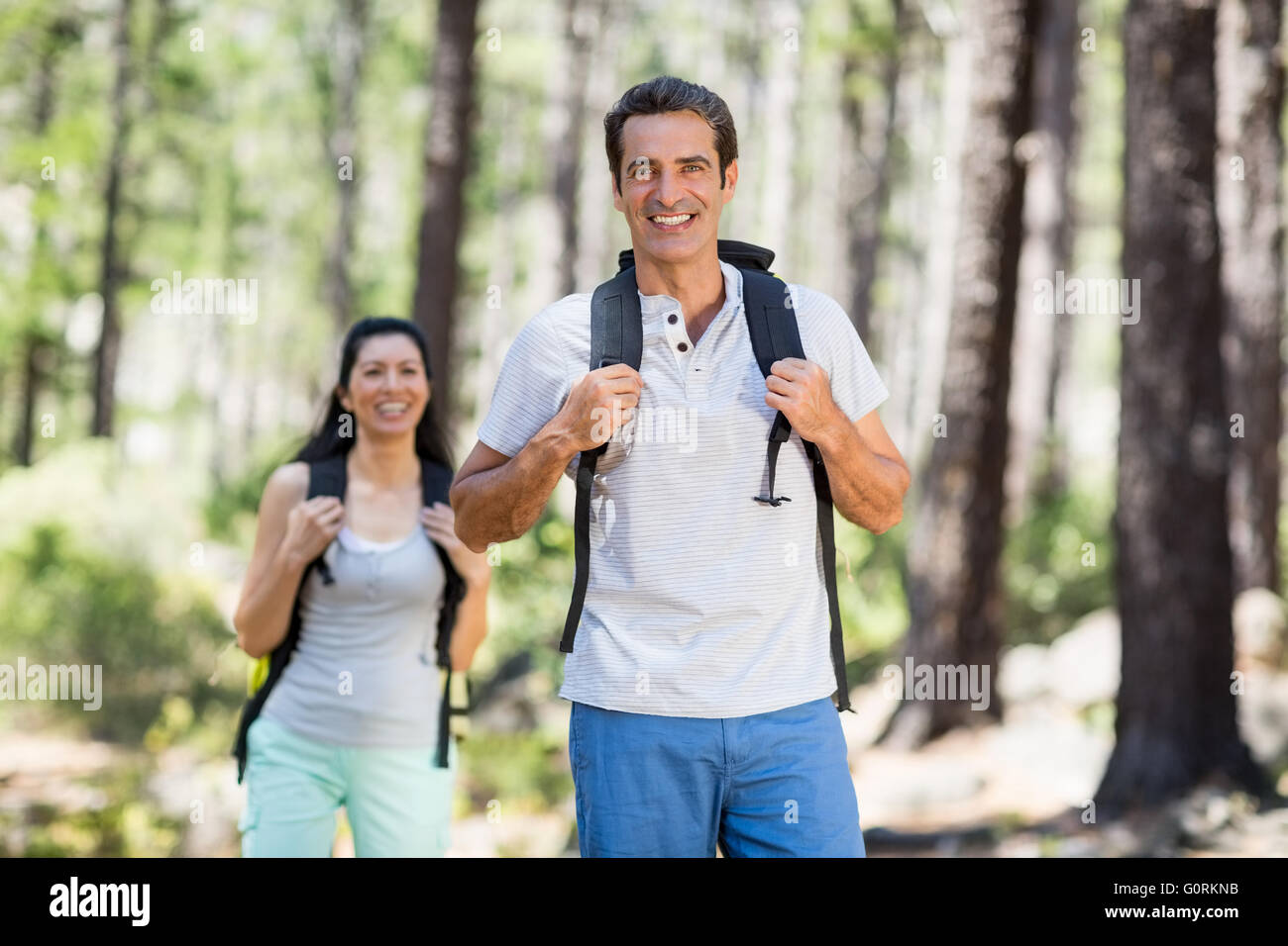 Couple smiling and hiking Stock Photo - Alamy