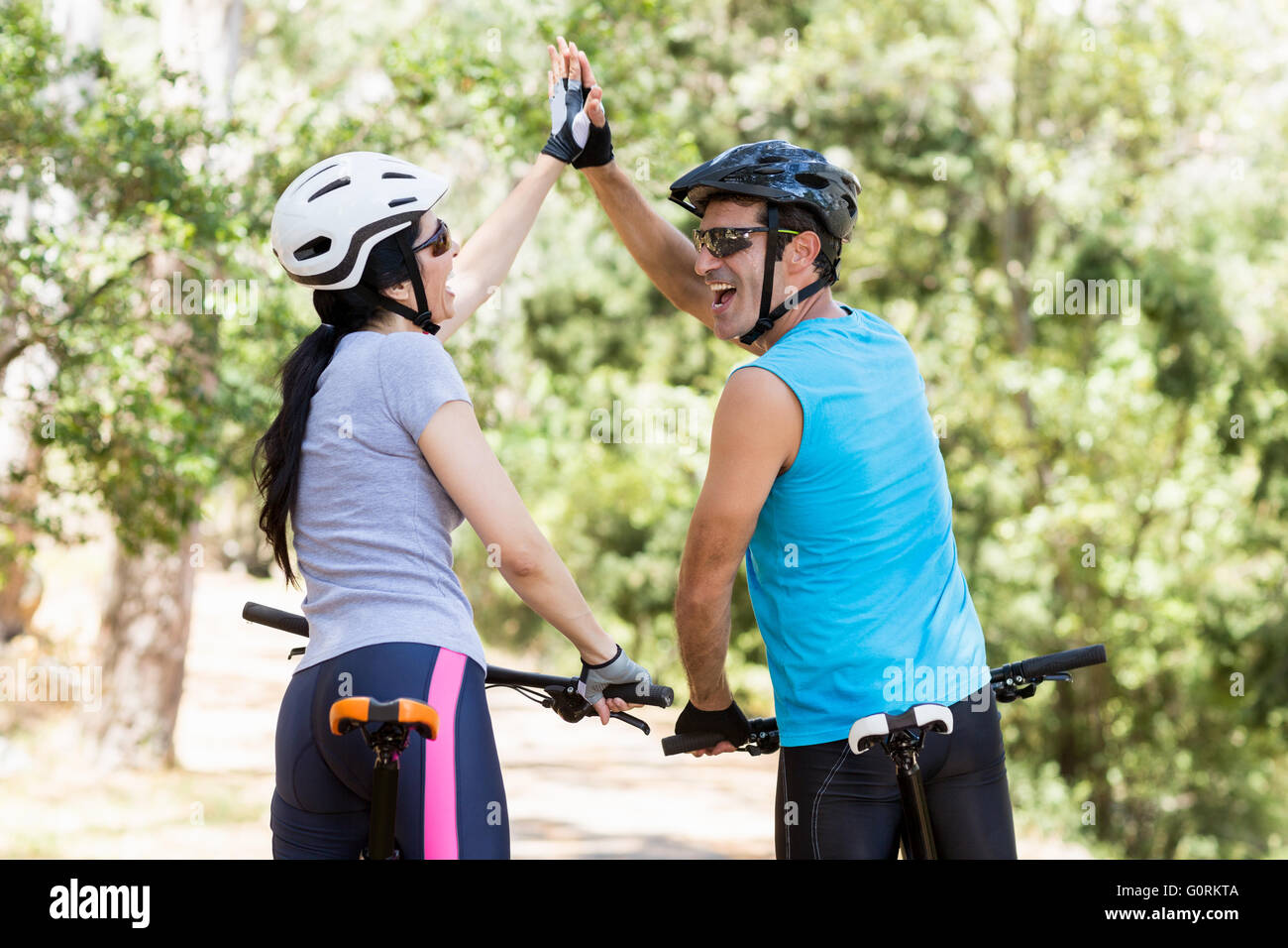 Couple from the back clapping hands each other Stock Photo - Alamy
