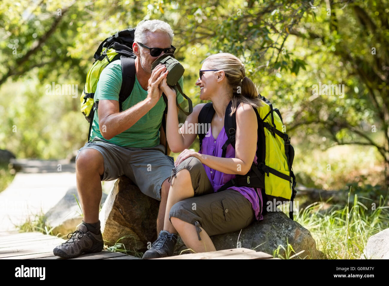 Couple taking a break during a hike Stock Photo - Alamy